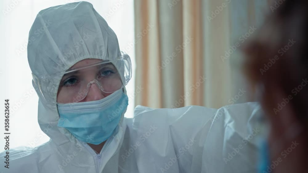 pandemic, female doctor in medical mask and glasses for protection ...