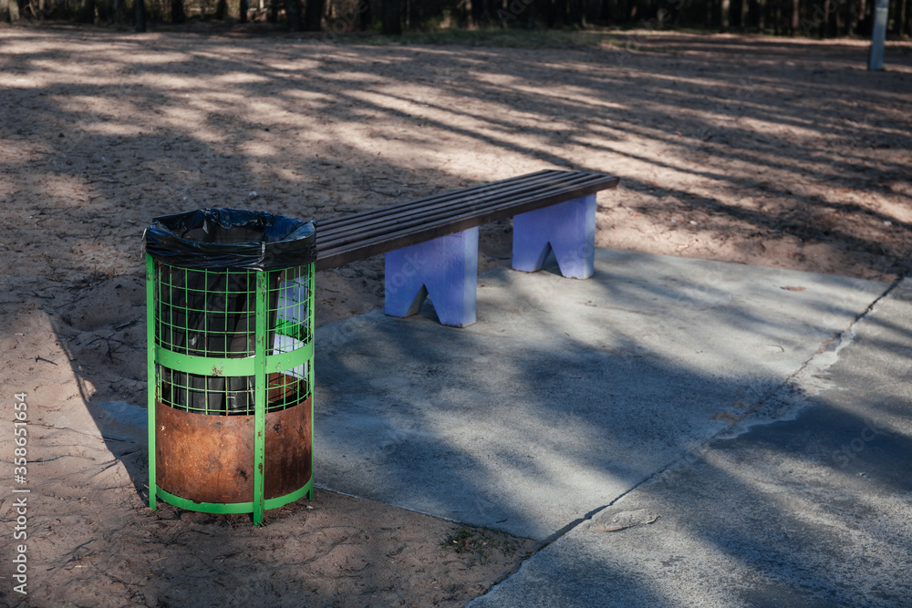 Emptied trash bin at the beach park . Clean streets . Pollution ...