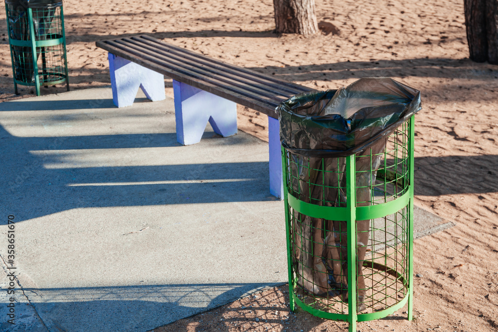 Emptied trash bin at the beach park . Clean streets . Pollution ...