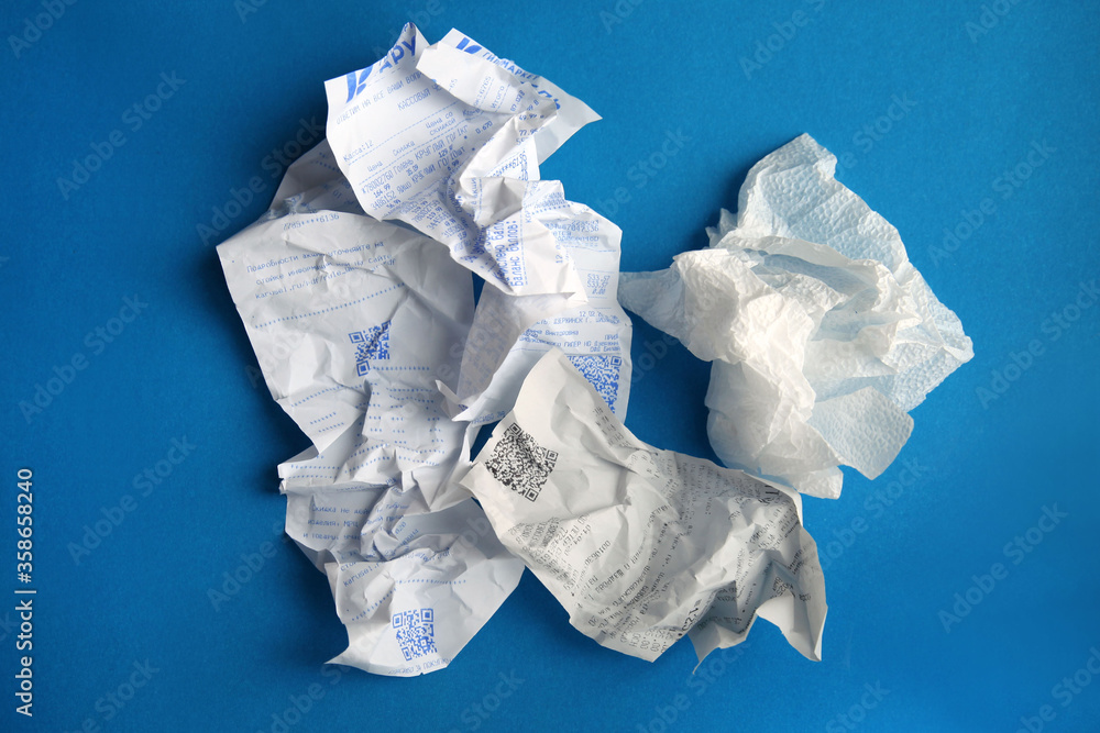 Crumpled paper is a kind of garbage on a blue plain background. Concept ...