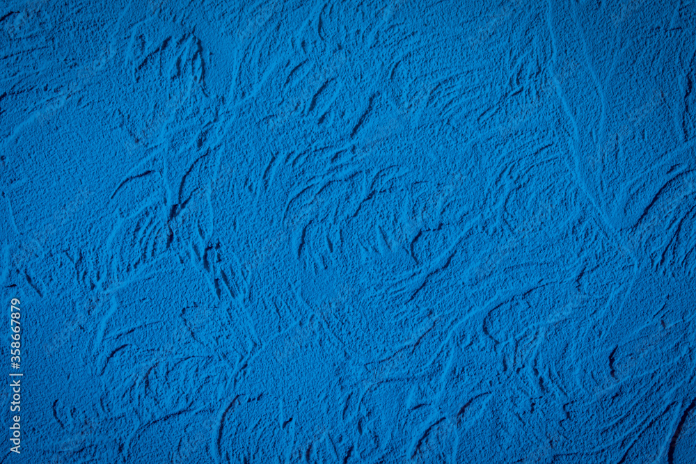 Dark Blue wall is finished with decorative plaster. Abstract streaks ...