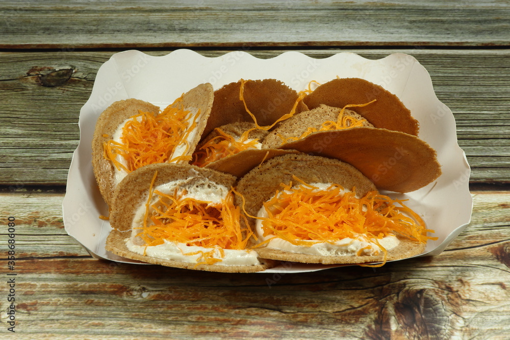 Thai crispy pancake with sweet egg floss and cream in the paper tray ...