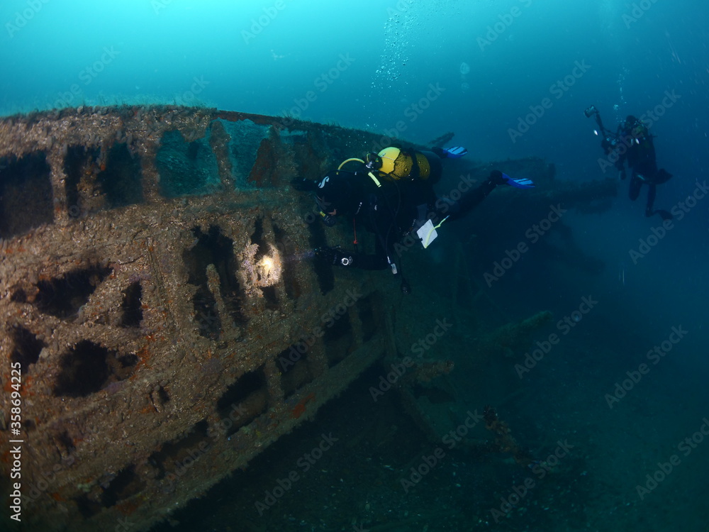 scuba divers exploring shipwreck underwater u boat submarine from world ...