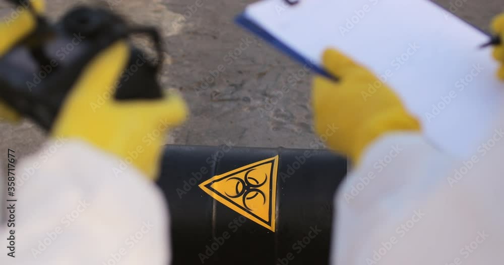 A close up of the hands of scientists who write in a form and take a ...