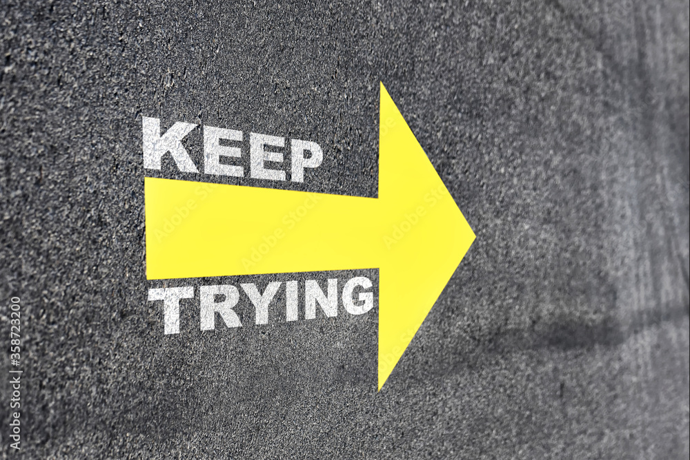Keep trying word with yellow arrow on road, Business challenge concept ...