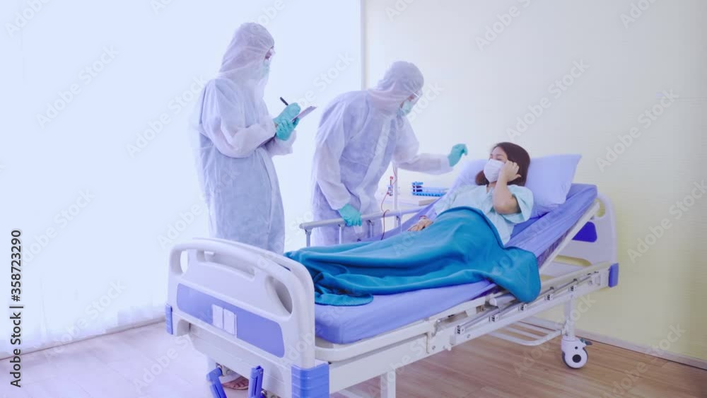 The doctors are examining the Asian female patient Who lay down on ...