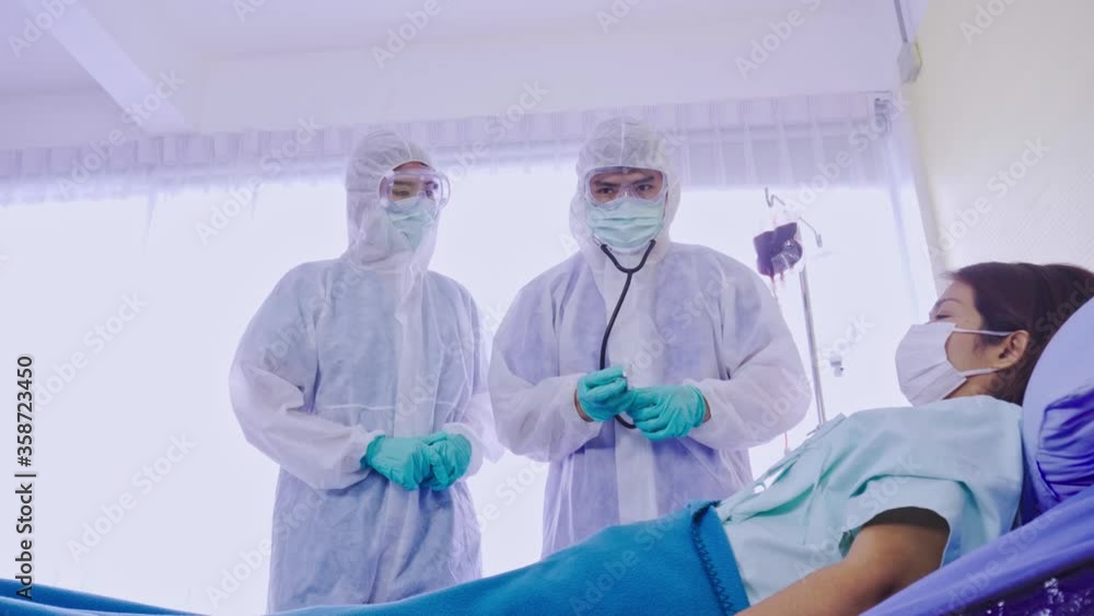 The doctors are examining the Asian female patient Who lay down on ...