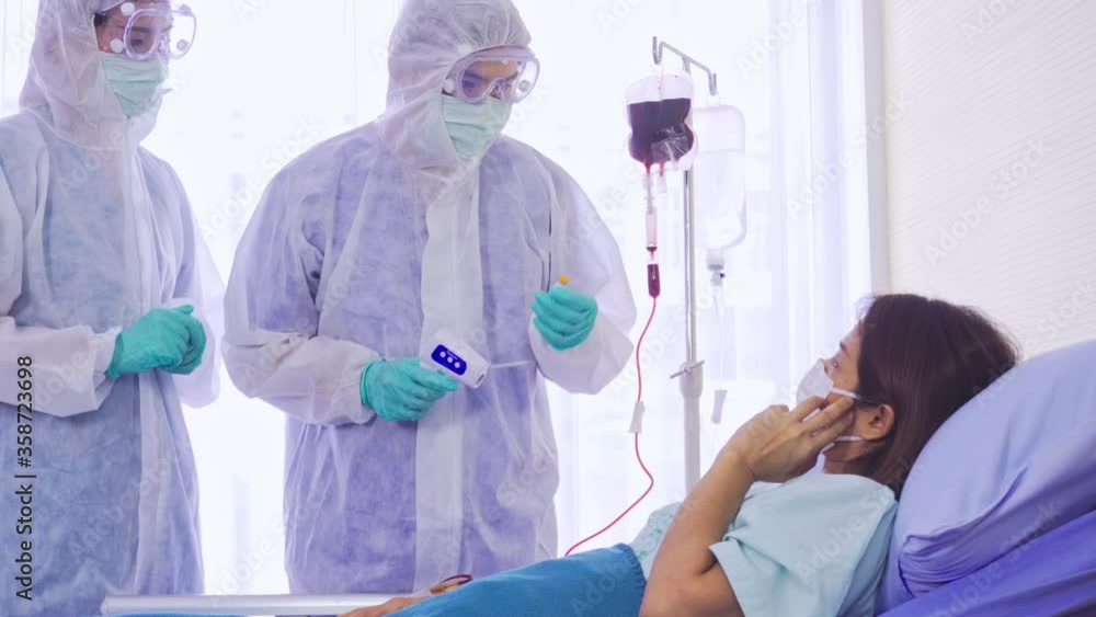 The doctors are examining the Asian female patient Who lay down on ...