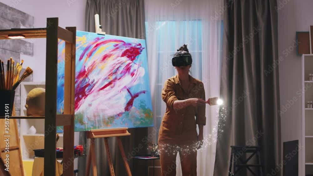 Female painter using virtual reality headset to create next masterpiece ...