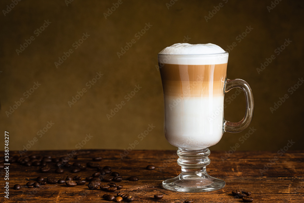 Cafe latte macchiato layered coffee in a see through glass irish coffee ...