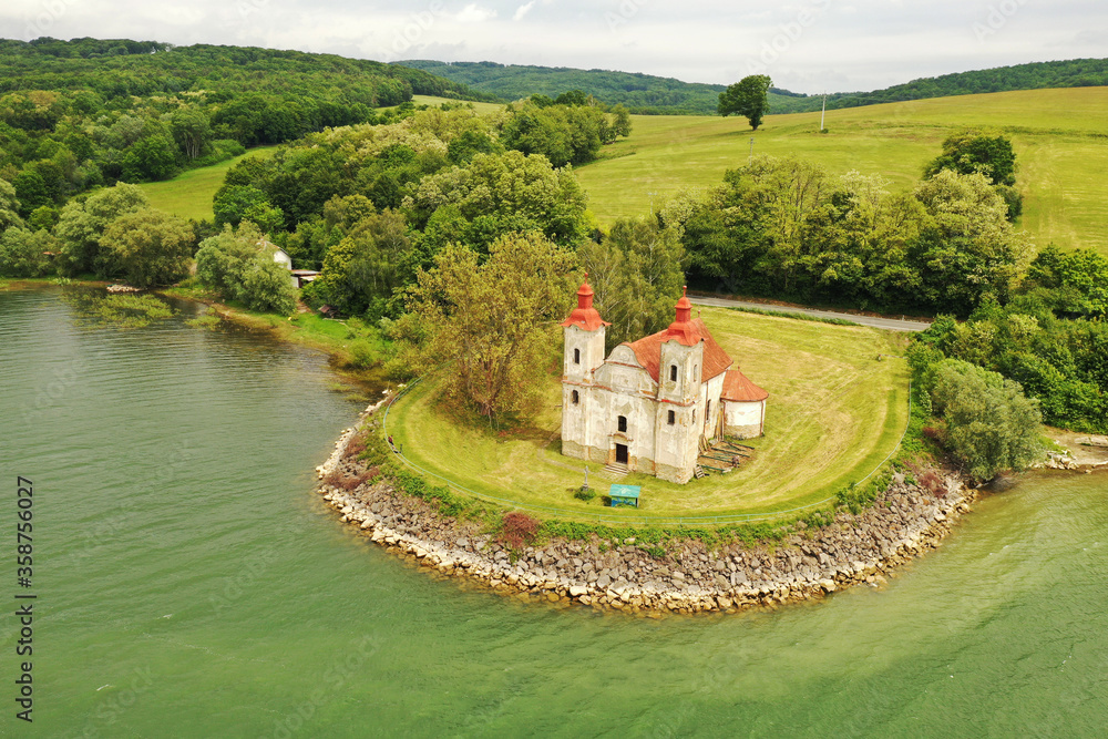 Aerial view of the historic church at the Velka Domasa dam in Slovakia ...