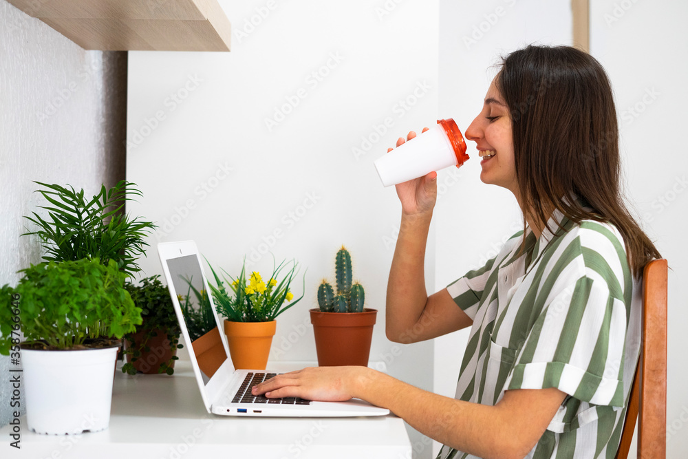 Female office worker drinking takeaway coffee at work. Concept of ...