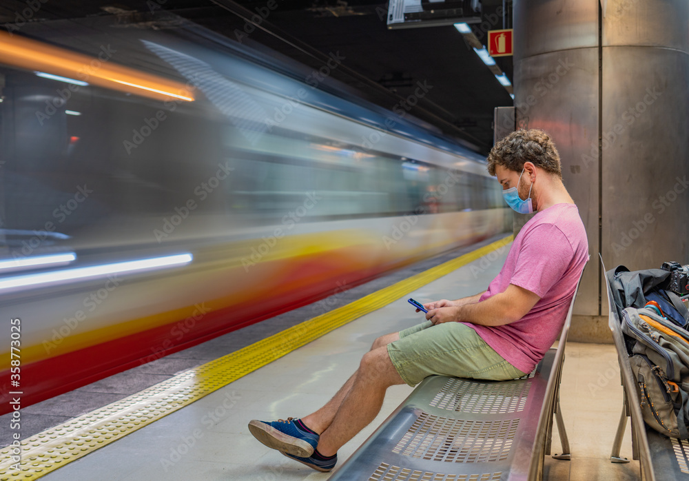 Mallorca public transport, Young man waiting for subway sitting on a ...