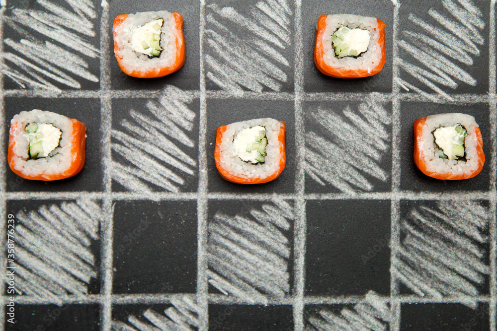 Five pieces of Philadelphia sushi roll on dark chalkboard background ...