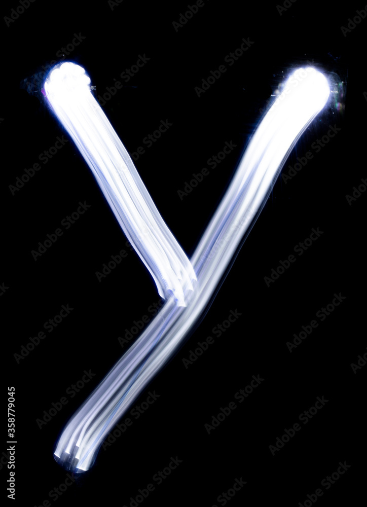 Handwrite letter Y, made with light painting technic isolated on black ...