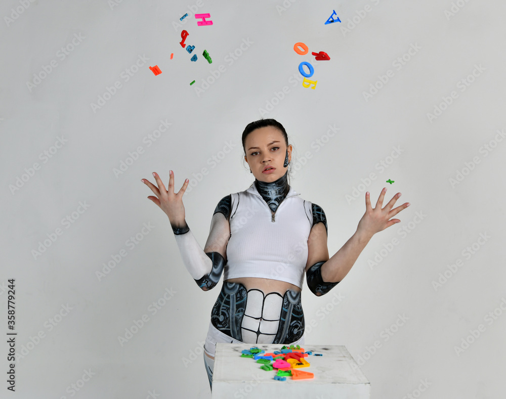 beautiful brunette girl in a robot suit plays various objects and ...