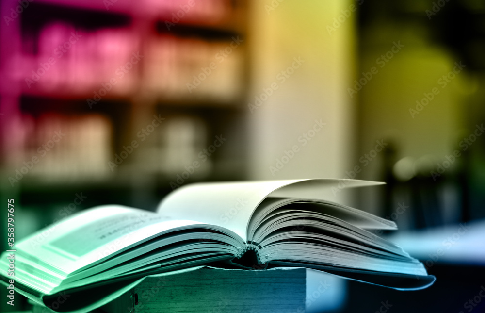 Open Book on wood table and blurred bookshelf in the library, education ...