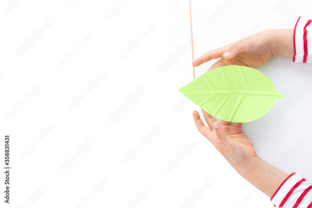 kids hands push strips on a green leaf shape paper detail, simple paper ...