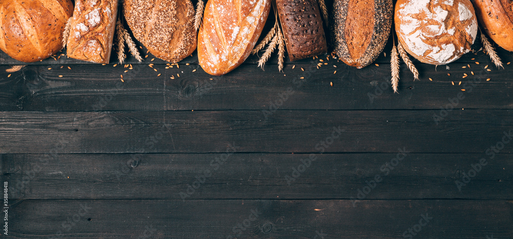Bread border on black wood background with copy space. Composition of ...