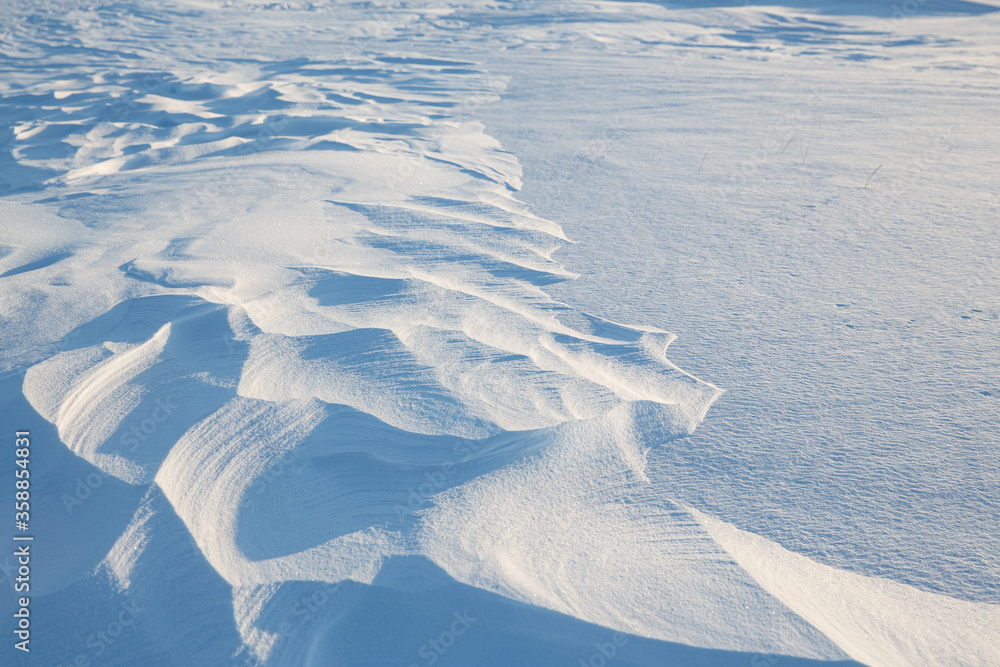 Snow texture. Wind sculpted patterns on snow surface. Wind in the ...