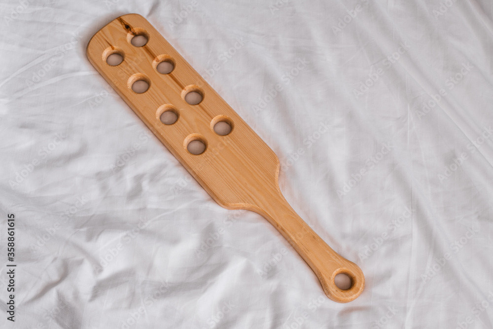 Wooden paddle for spanking with holes isolated on white background ...