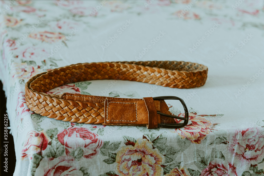 Old vintage brown leather belt. Home child abuse. Domestic corporal ...