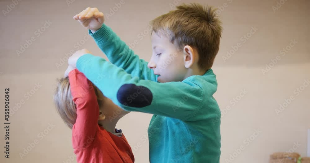 Happy children measuring to determine who is bigger, power struggle ...