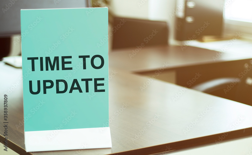 blue board with text "TIME TO UPDATE" on the office background Stock ...