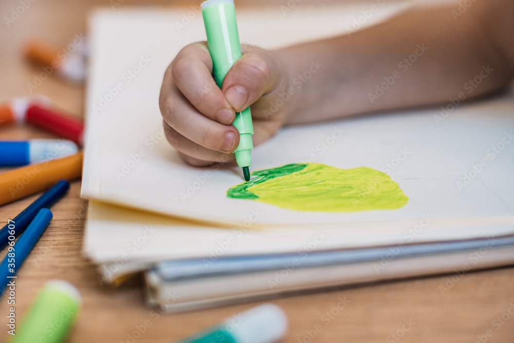 child's hand drawing a tree with colored markers Stock Photo | Adobe Stock