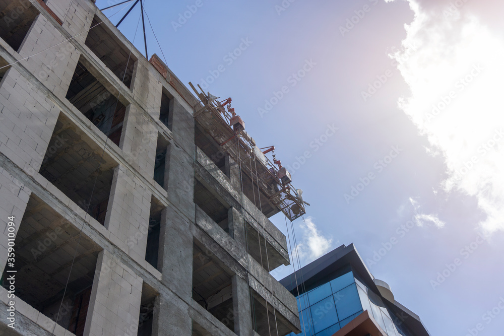Construction workers plaster the facade of the house. Application Of ...
