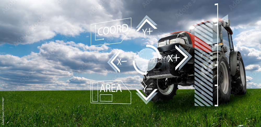 Autonomous remote controlled agricultural tractor on the field. Digital ...