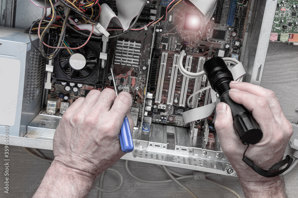 Repairing and assembling a desktop computer. Professional man repairing ...