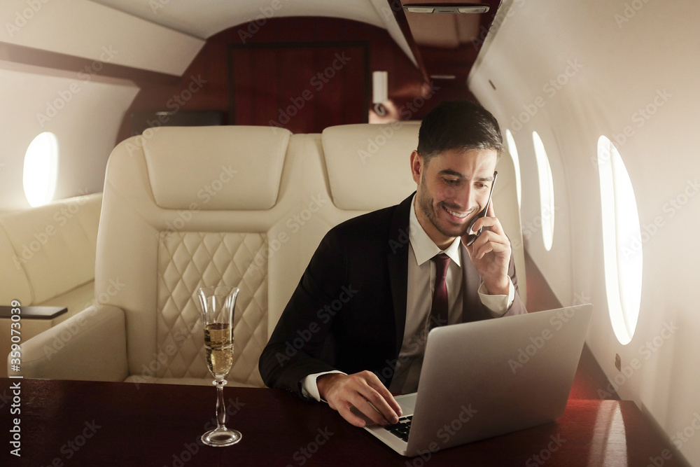 Fotka „Billionaire or rich business man flying first class and working ...