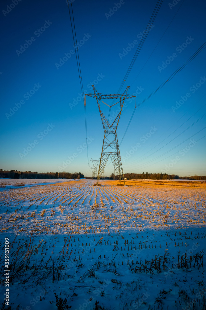 High voltage electricity transmission towers by aerial cables in winter ...