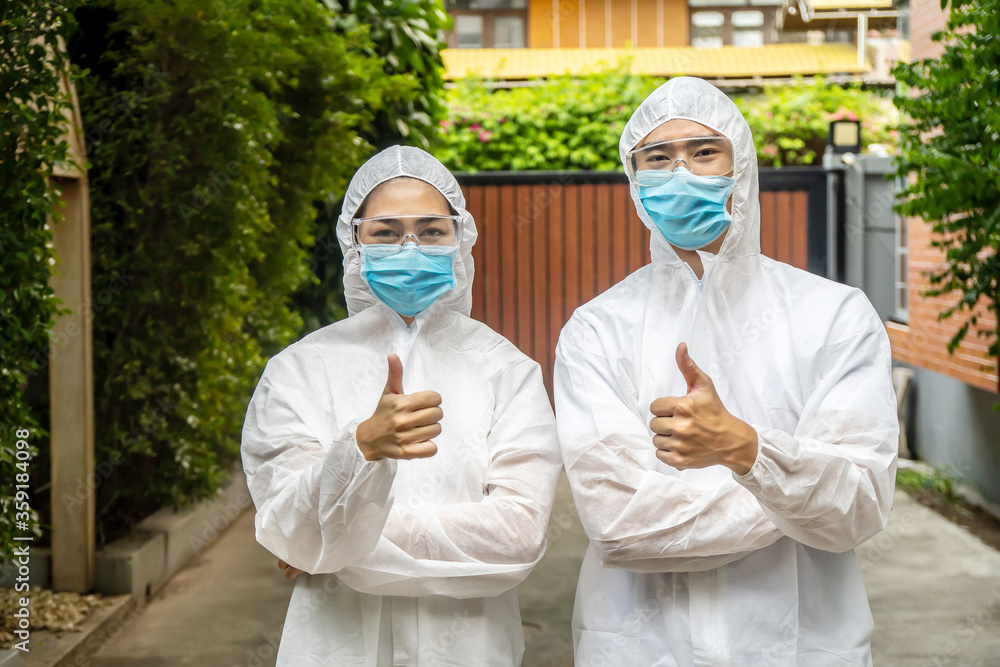 Asian doctor man and nurse woman wear PPE suit or Personal Protective ...