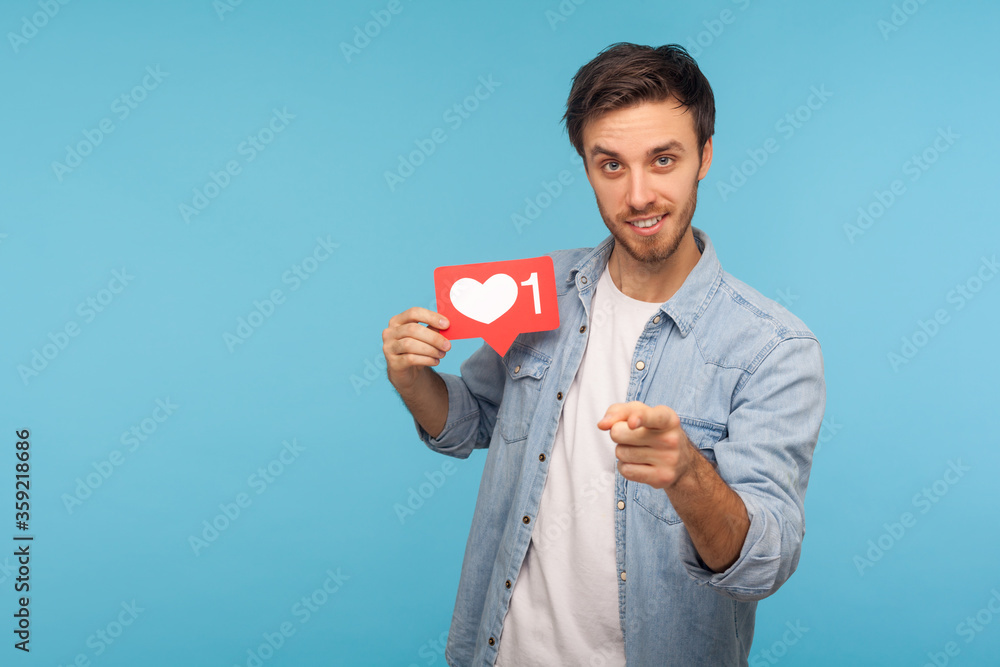 Hey you, click Like! Portrait of handsome blogger man in denim shirt ...