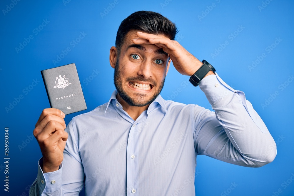 Young handsome tourist man holding australia australian passport id ...