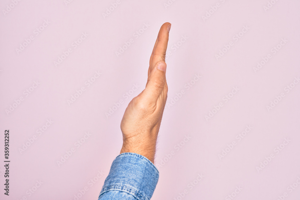 Hand of caucasian young man showing fingers over isolated pink ...