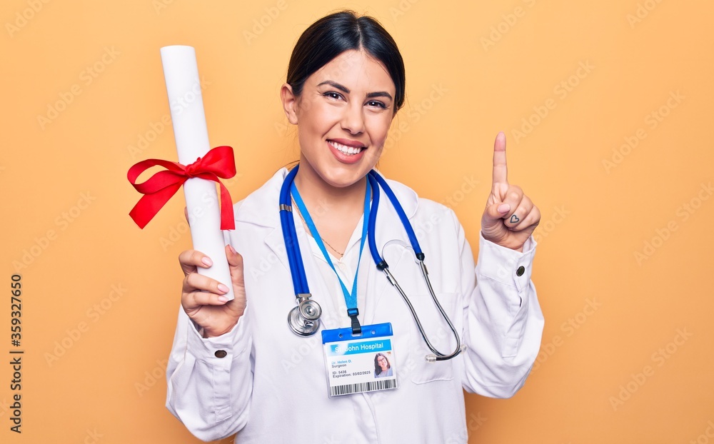 Young beautiful doctor woman wearing stethoscope holding diploma degree ...