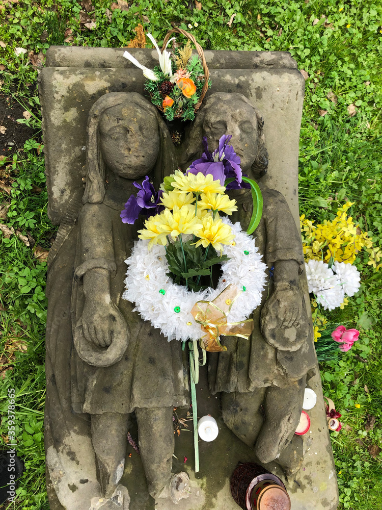 Ancient childrens' grave in a gothic cemetery where two sisters are ...