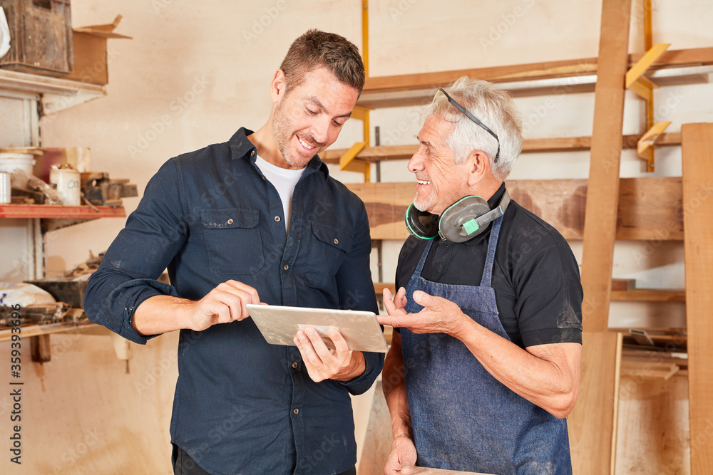 Apprentice and master with tablet are happy Stock Photo | Adobe Stock