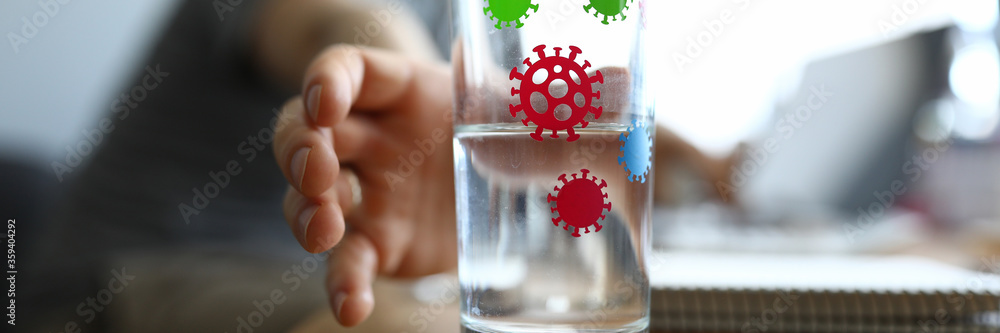 Hand reaches for glass infected with coronavirus. Acute respiratory ...