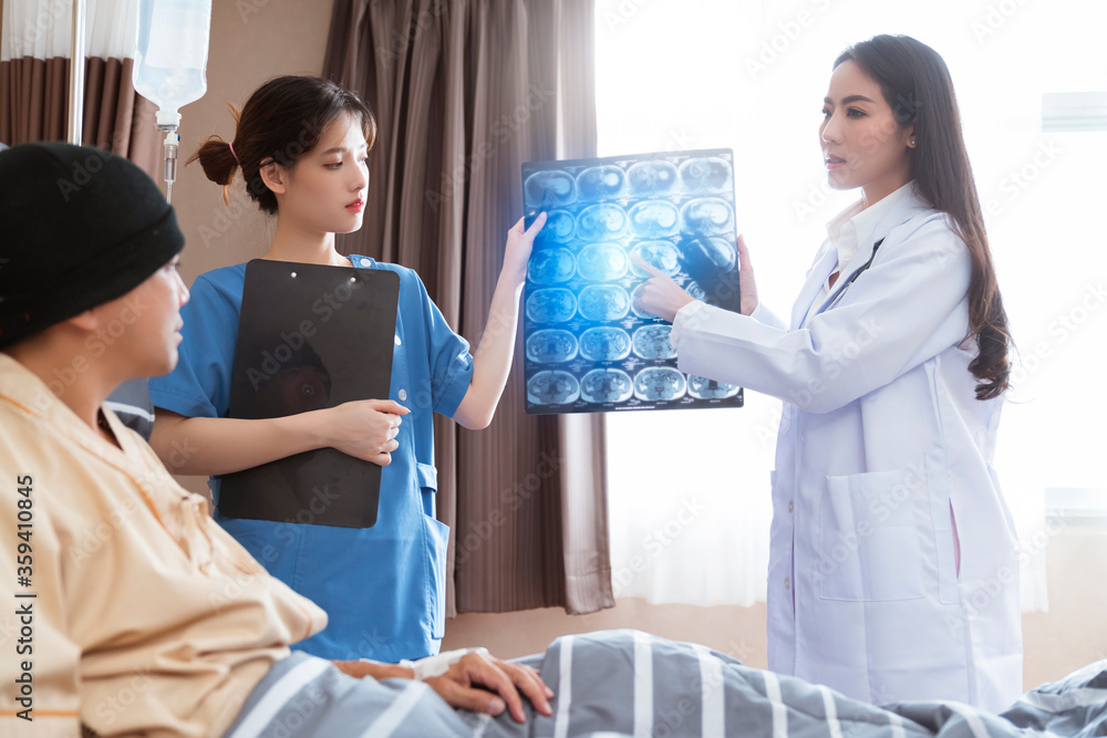 asian female Expert doctor and physiotherapist with nurse explaining x ...