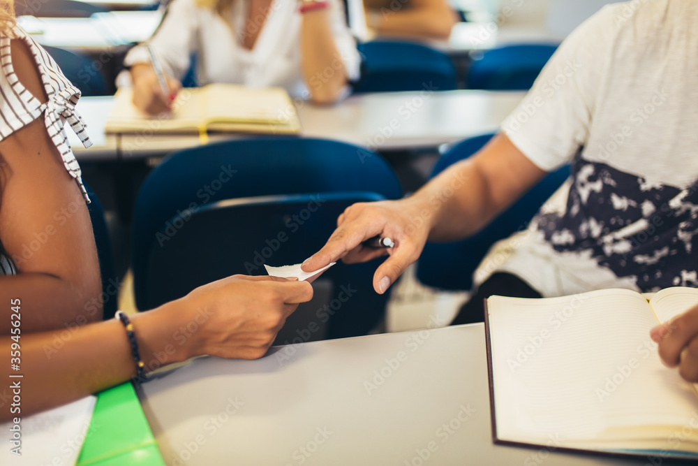Students during test cheating with cheat sheet Stock Photo | Adobe Stock
