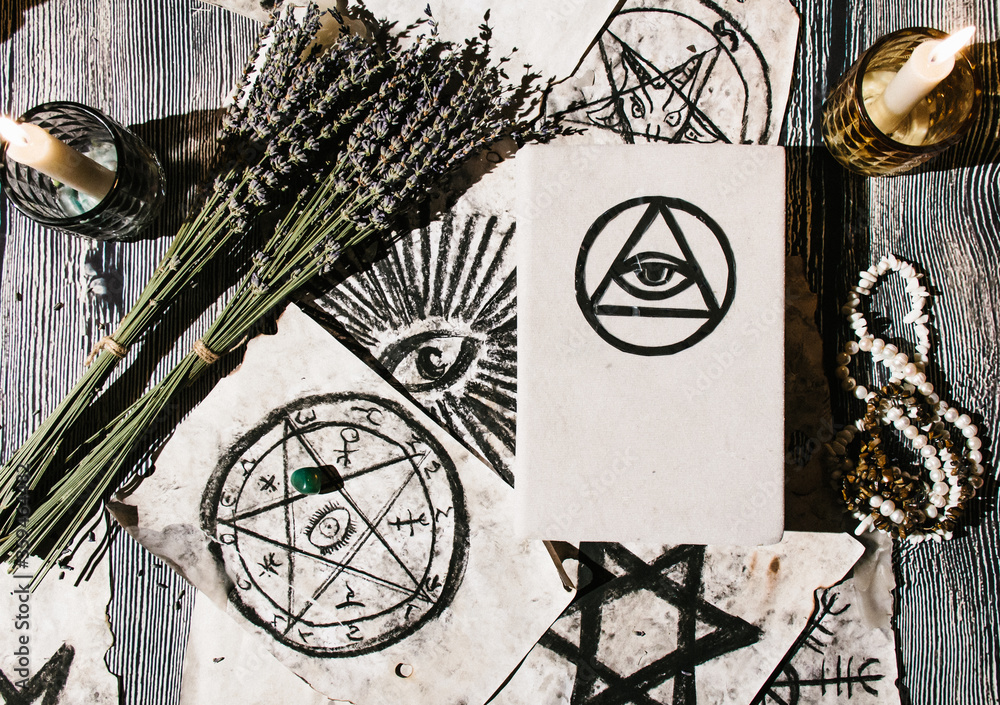 White magic book laying on the table with old manuscripts with occult ...