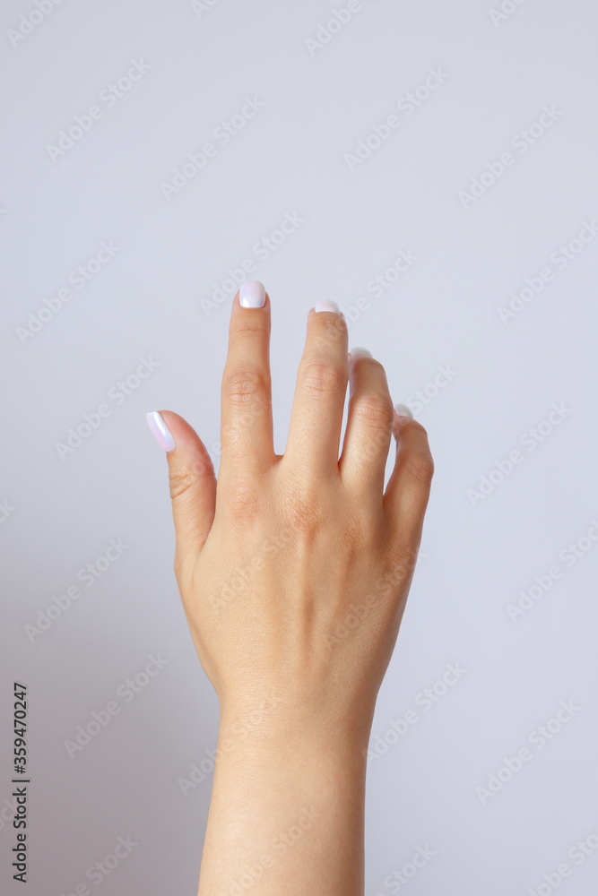 Gesture and sign, female hand pressing a button or screen, on a light ...