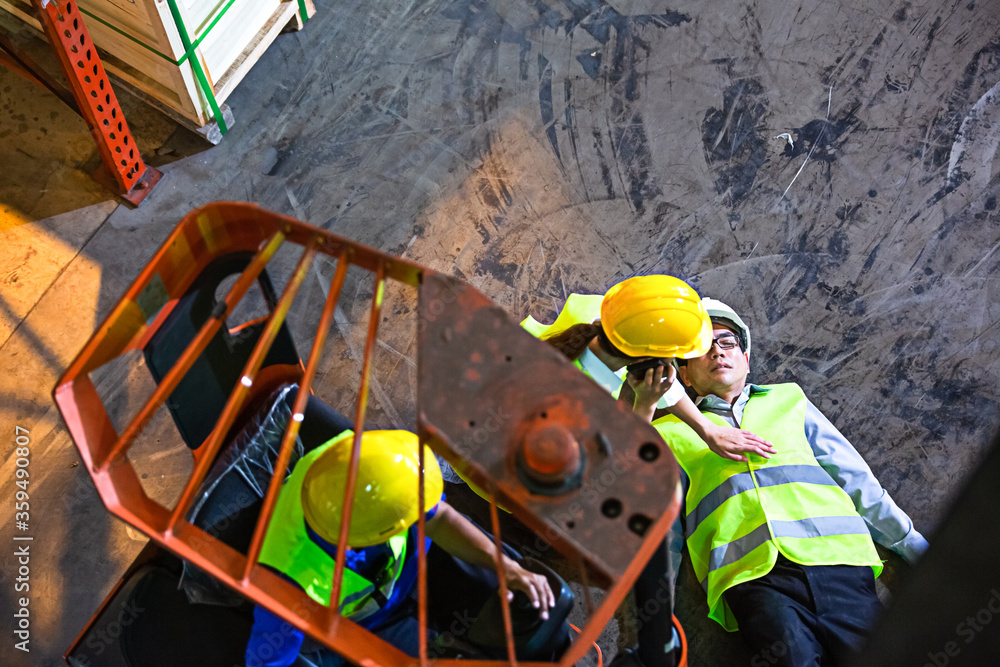 top view of warehouse worker lying down on floor after accident from ...