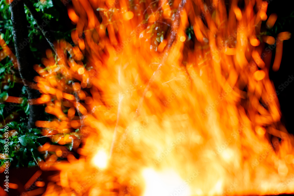 the flame of a fire from a campfire in nature. sparks in the night ...
