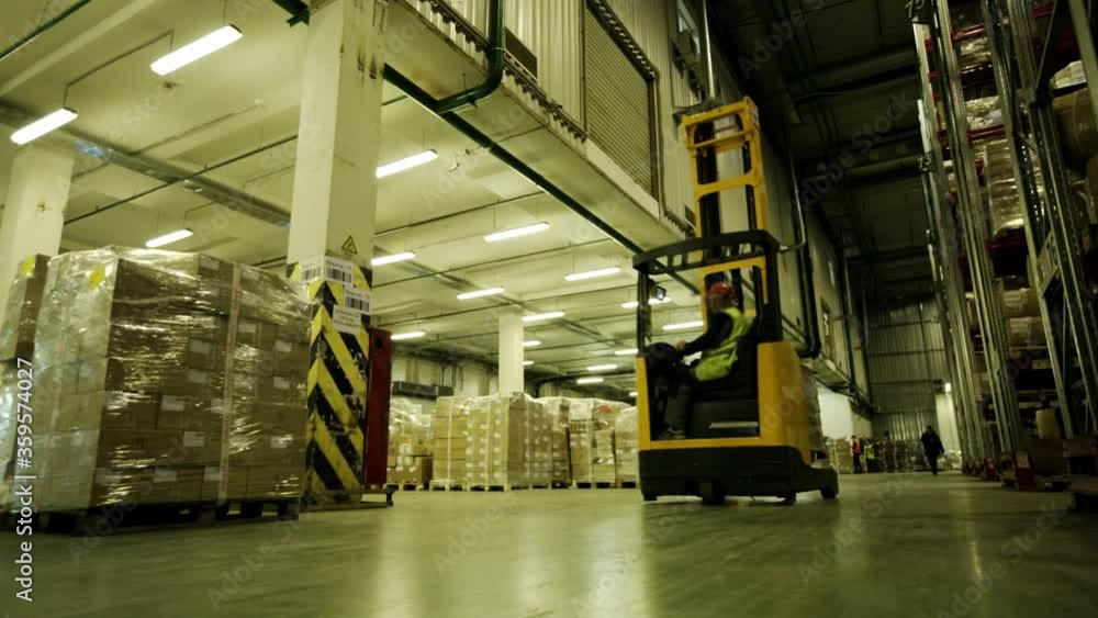 Forklift rides on in logistic warehouse with pallet. Logistic warehouse ...