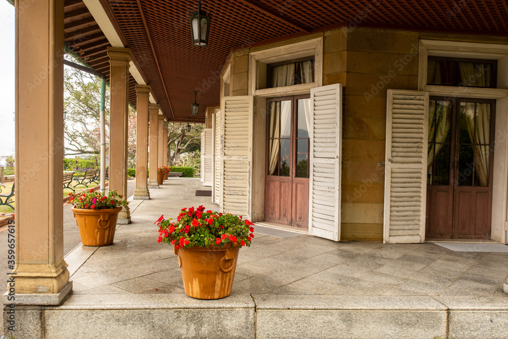 Colonial style old european building with terrace, columns and window ...